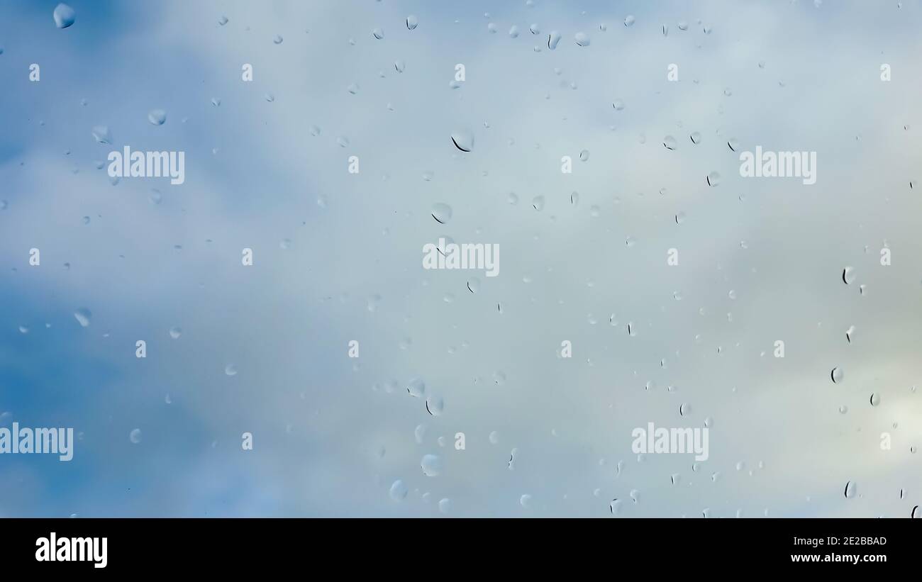 Rain drops running down a window in a close up view Stock Photo - Alamy