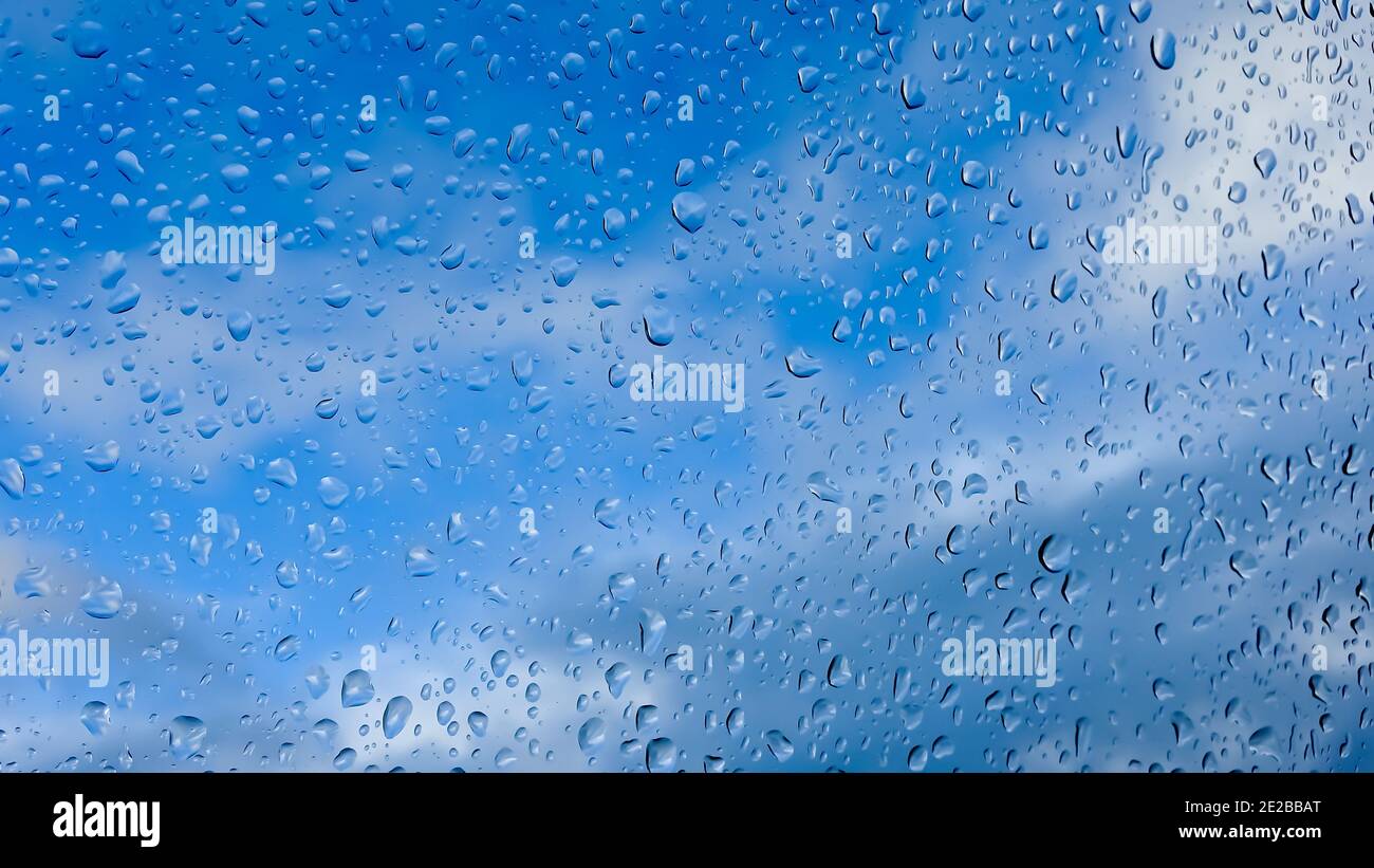 Rain drops running down a window in a close up view Stock Photo - Alamy