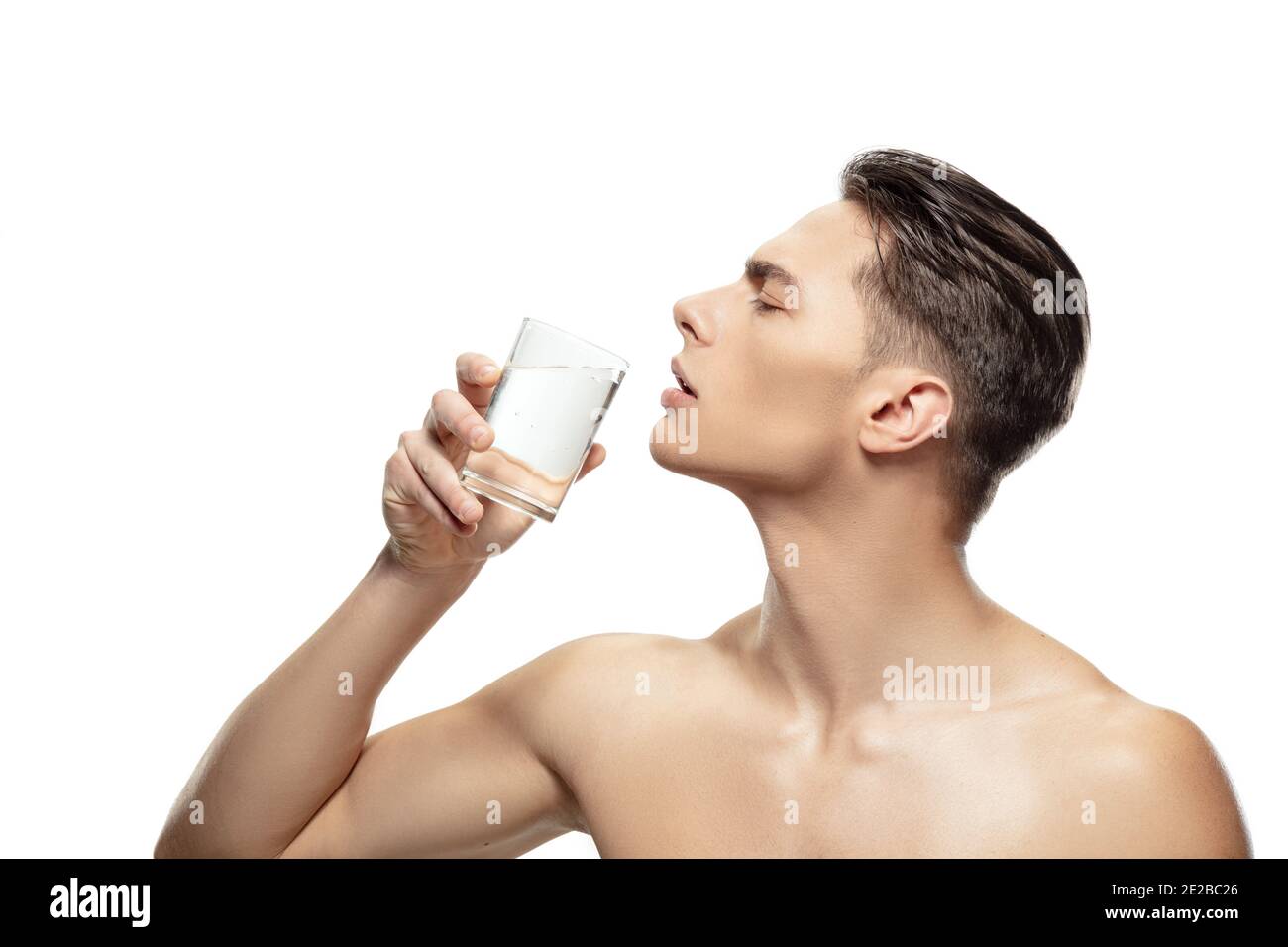 Pure water. Portrait of young man isolated on white studio background ...