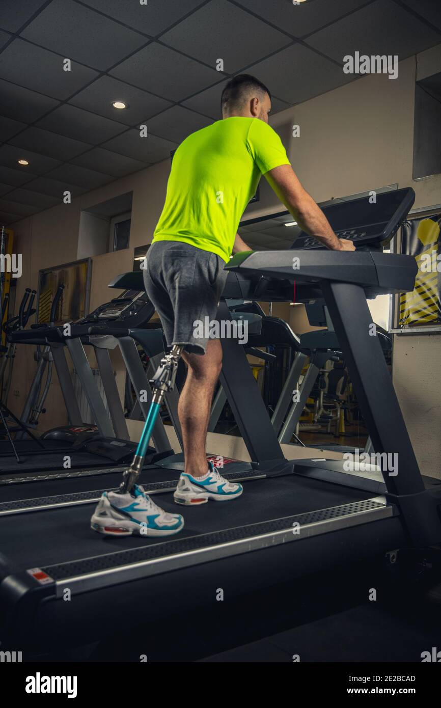 Athletic. Disabled man training in the gym of rehabilitation center ...