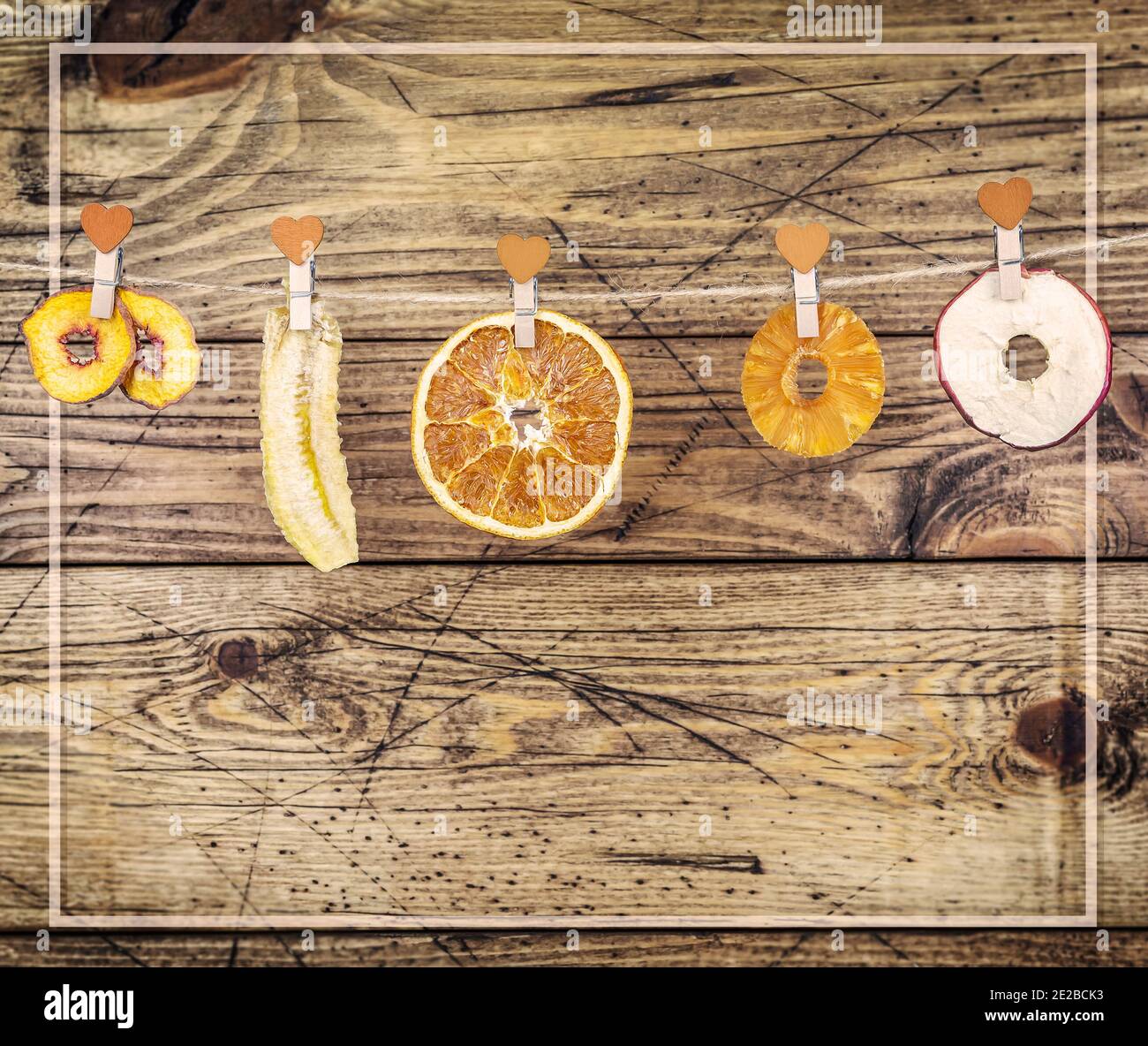 Dry slice fruits apple, banana, orange, pineapple, pear on a wooden ...