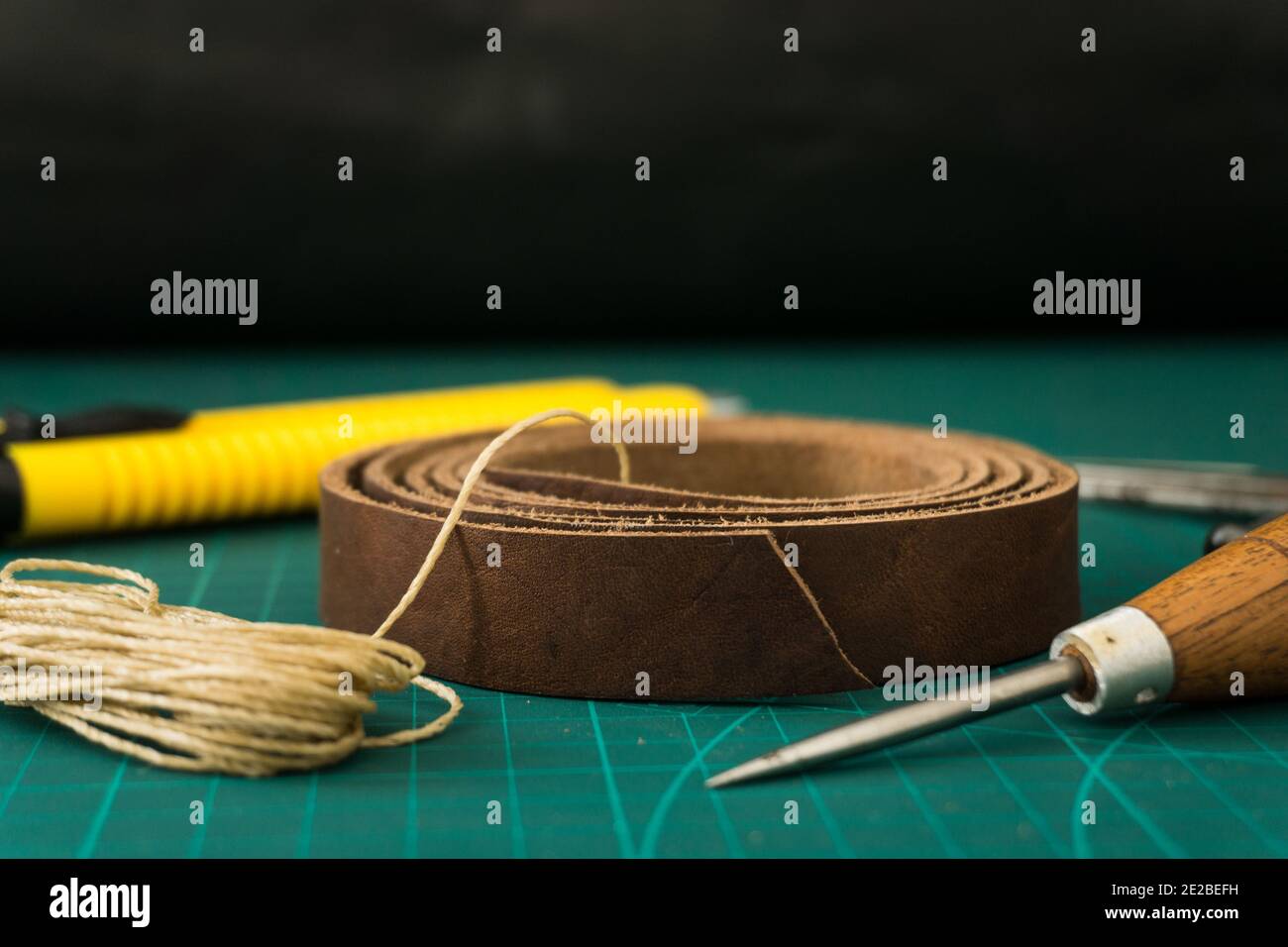 Closeup shot of leatherworker working tools on a craftsman's work table ...