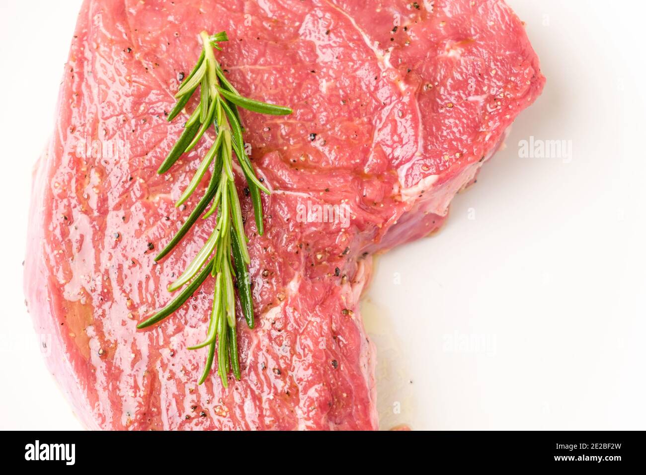 Raw beef steak meat with branch of rosemary and species isolated on a ...