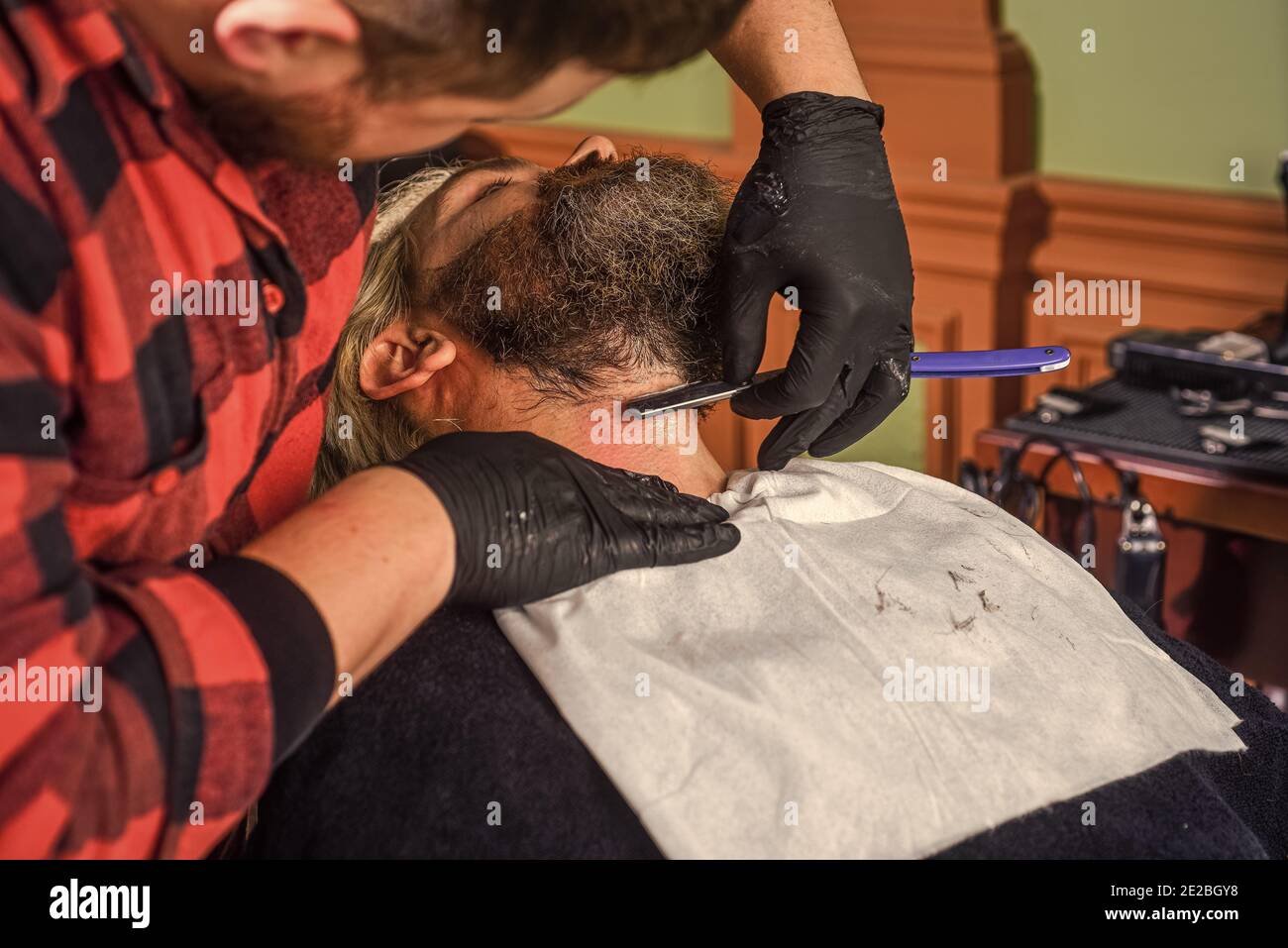 Shaving facial hair. Trimming beard. Barbershop services. Perfect look ...