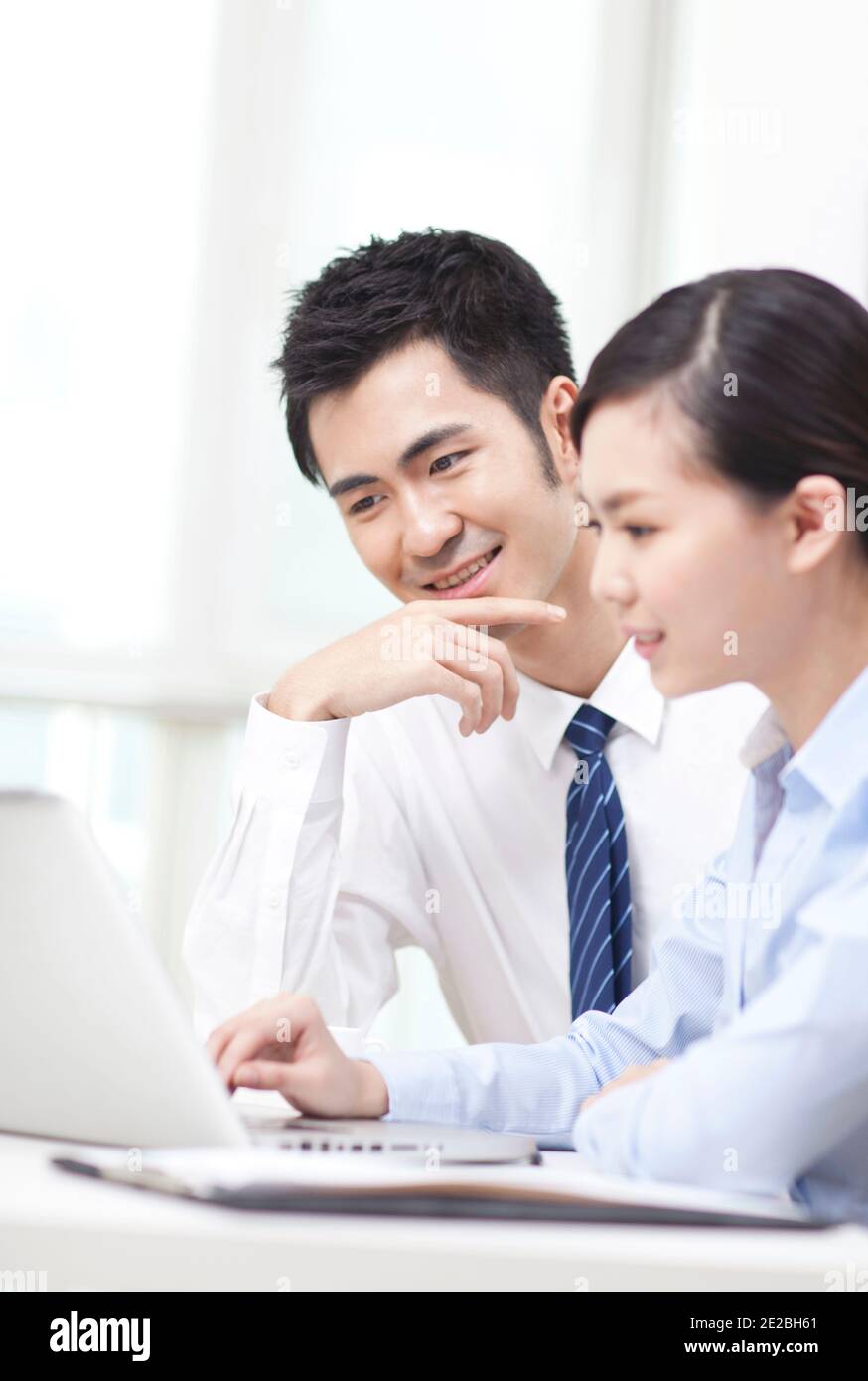 Businessman and businesswoman discussing working on computer high ...