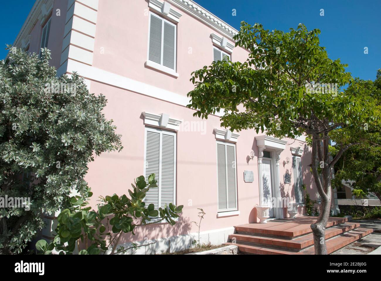 The old style Cockburn Town building painted in typical Caribbean pink ...