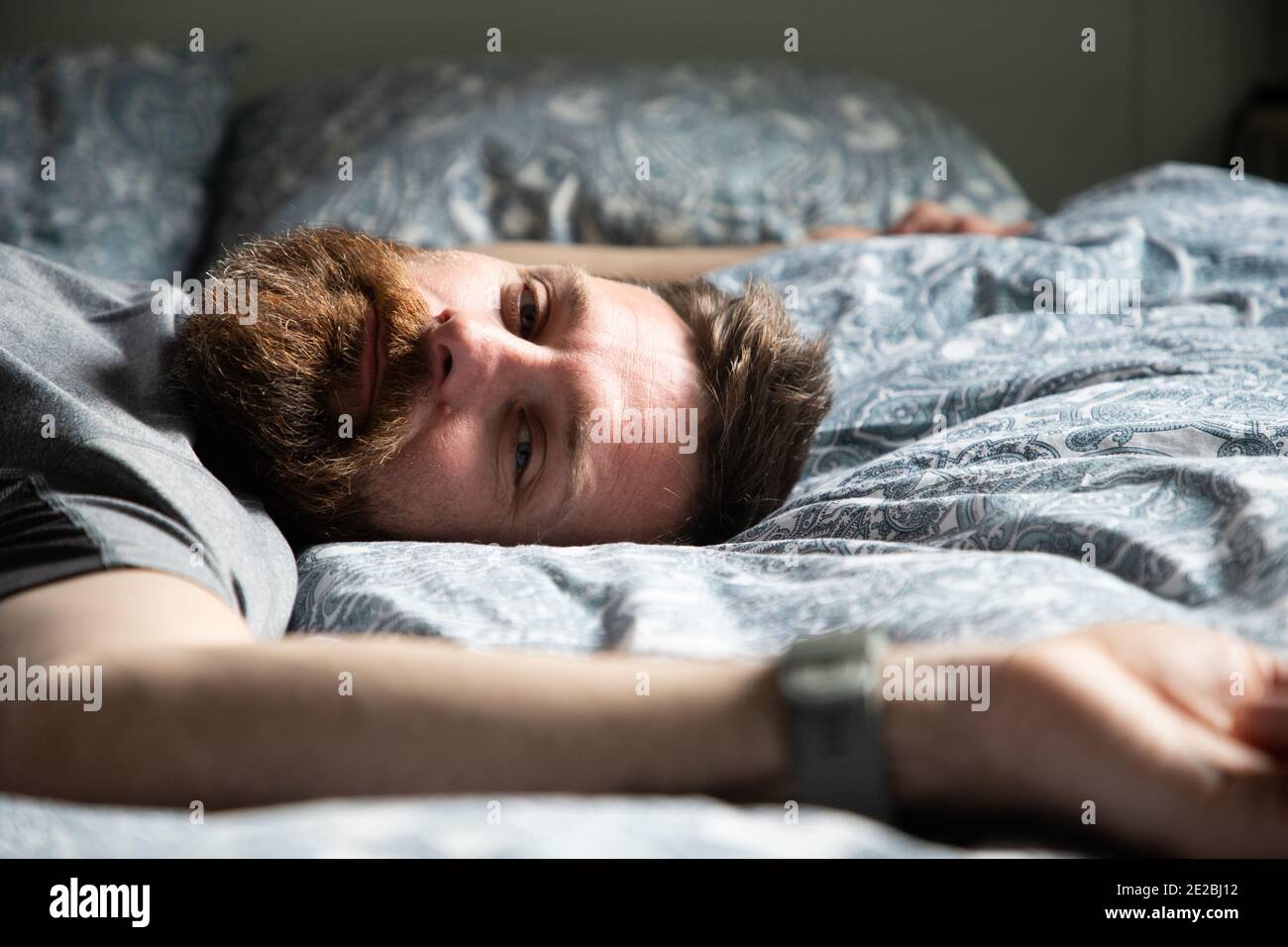 Man relaxing in bed hi-res stock photography and images - Alamy