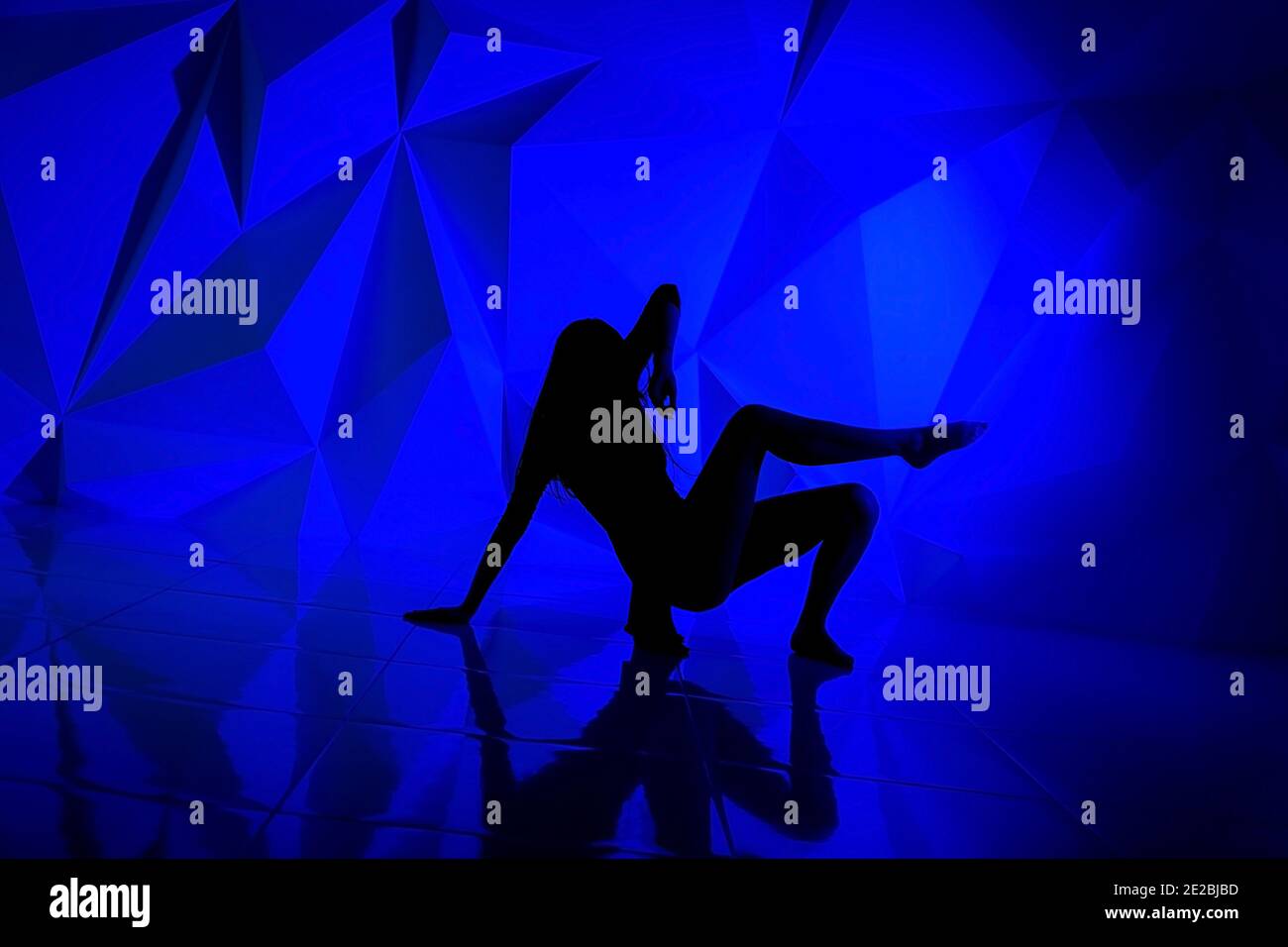 Woman dancing on the background of a beautiful multicolored wall. Sexy ...