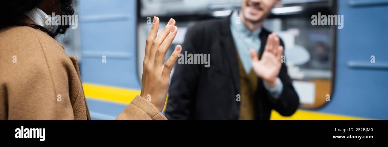 Young happy multicultural couple waving hi-res stock photography and ...