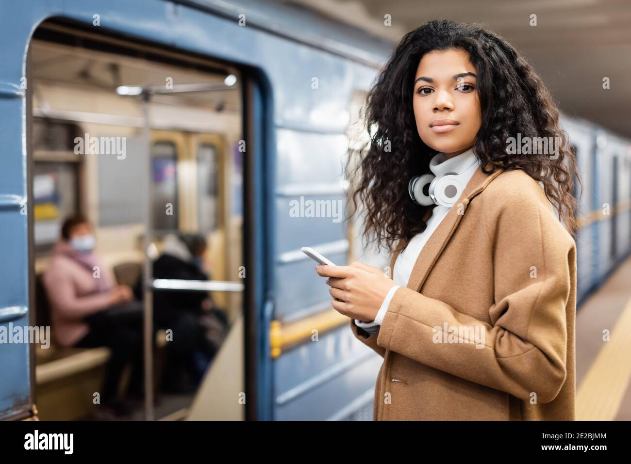 Woman with headphones metro hi-res stock photography and images - Alamy