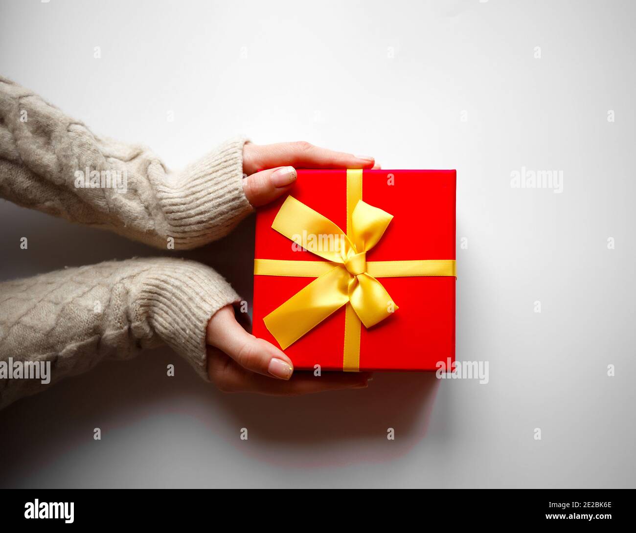 hands hold a gift on a white background Stock Photo - Alamy