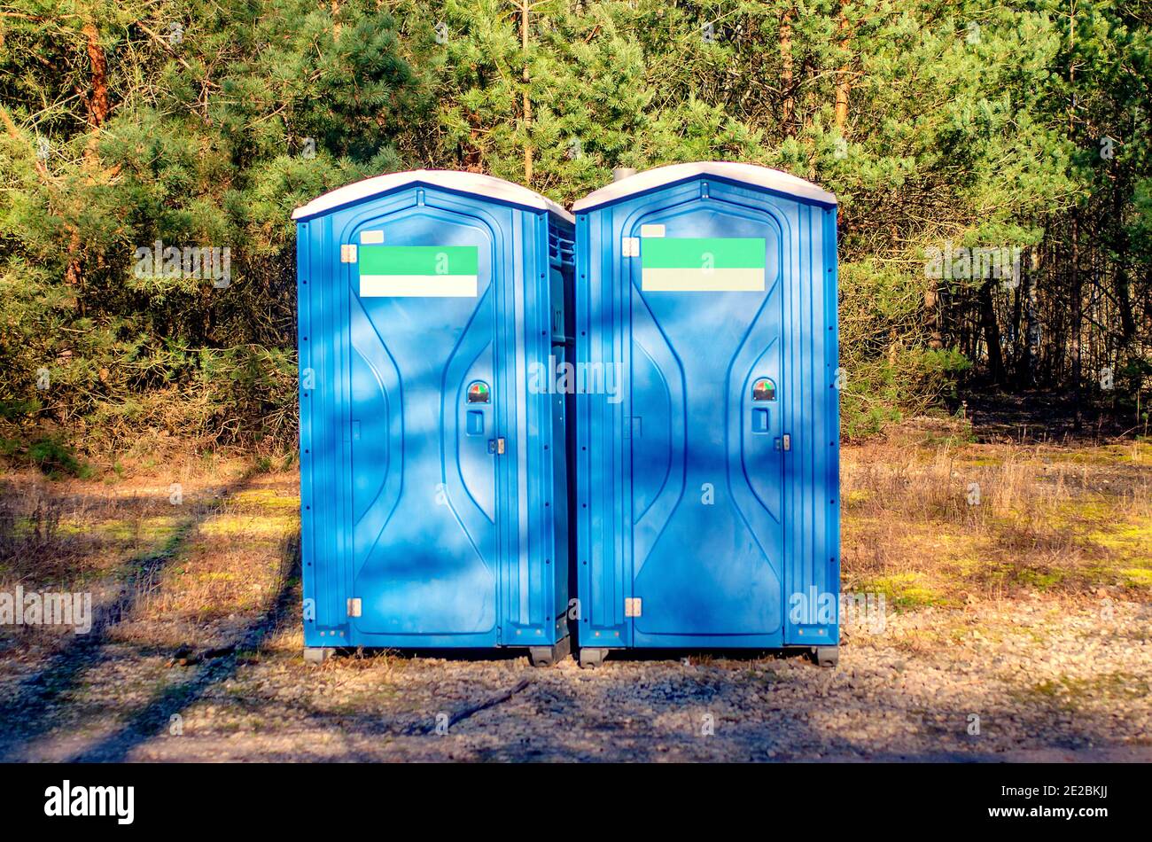Two blue plastic toilet cabins. Public toilet in the city park ...