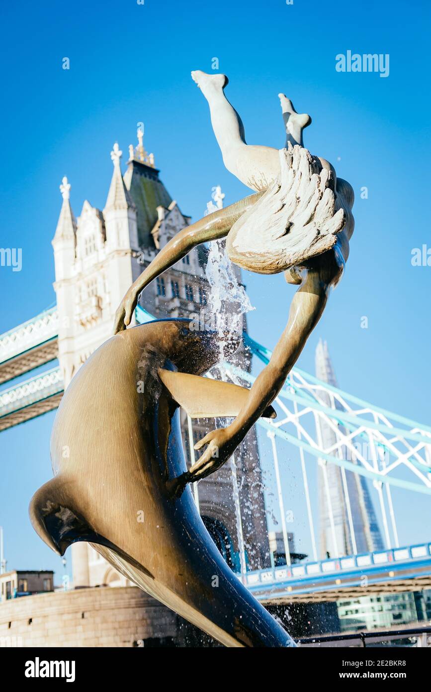 Girl with a Dolphin statue and fountain stands near Tower Bridge on the ...