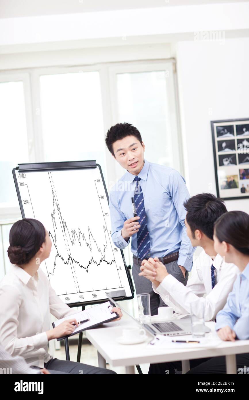 Smiling businessman presenting graph hi-res stock photography and ...