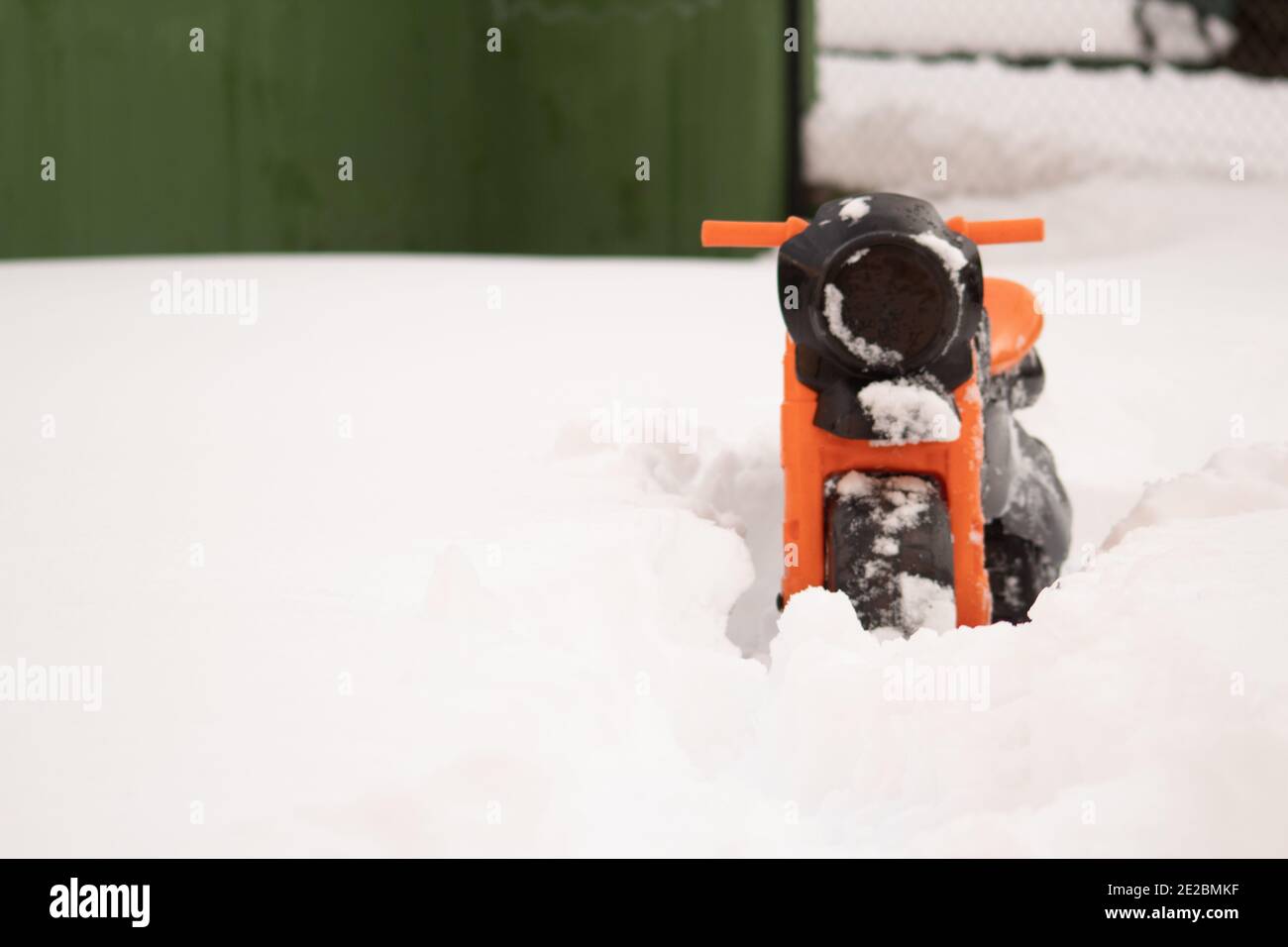 Selective focus shot of a black and orange sled in the snow Stock Photo ...