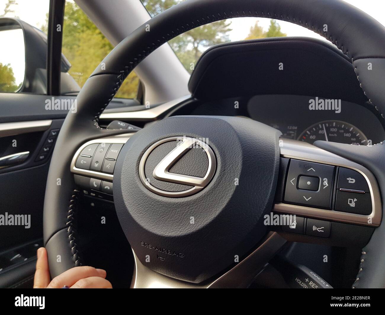 Close up view of female hand on steering wheel of Lexus RX car. Vehicle ...