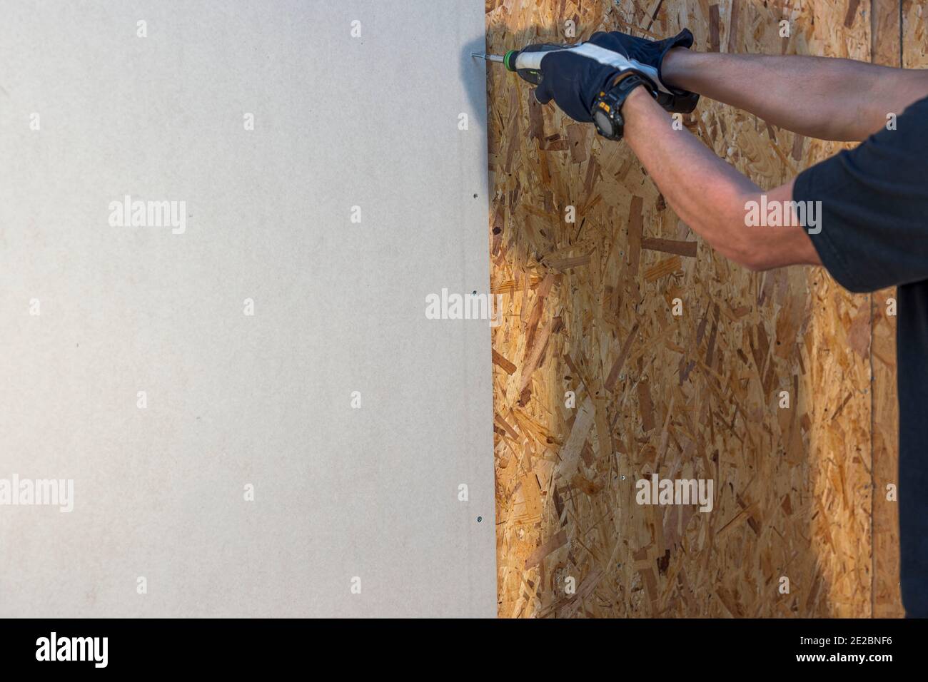 Close up view of worker building interior partition wall. Construction ...