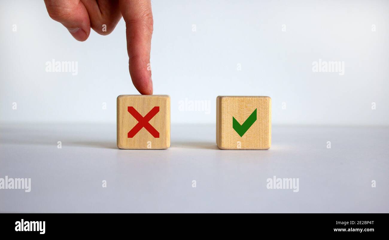 Yes or no choice symbol. Hand making a choice between two cubes with ...