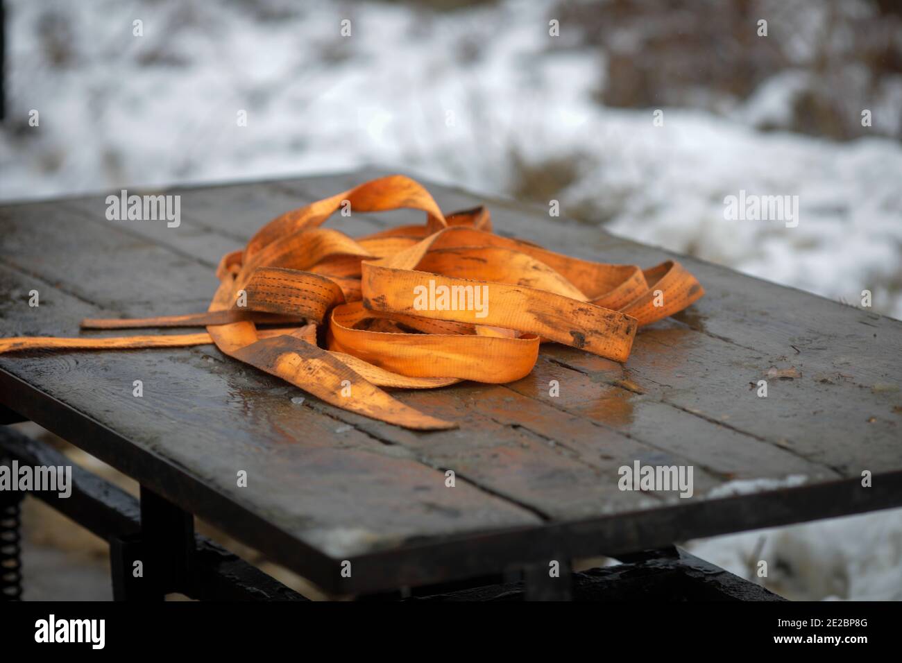 Ratchet straps used for lowering a casket in the grave on a cart used ...
