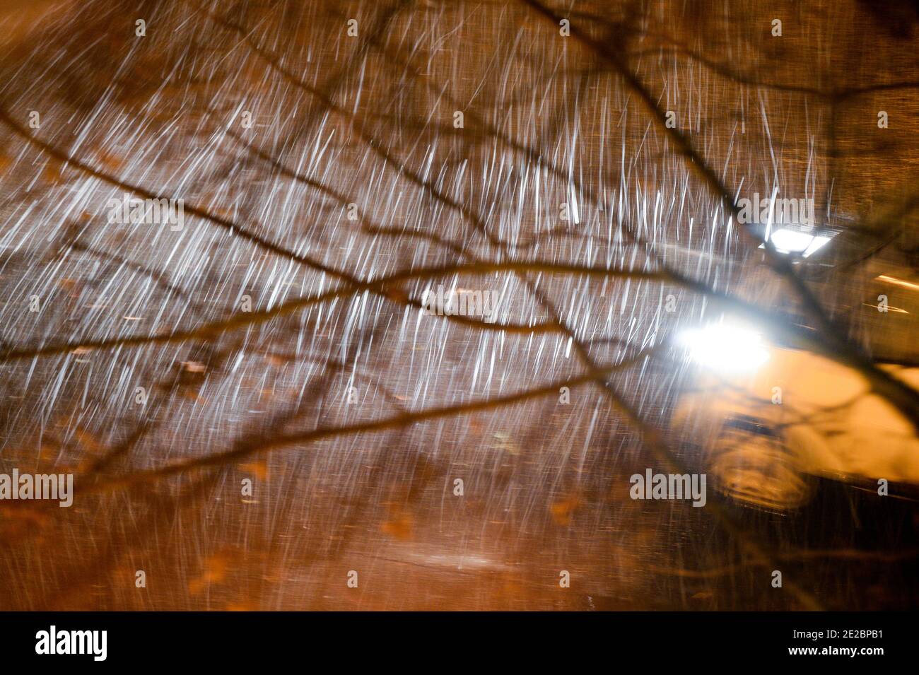 Berlin, Germany. 13th Jan, 2021. The headlights of a car illuminate the ...