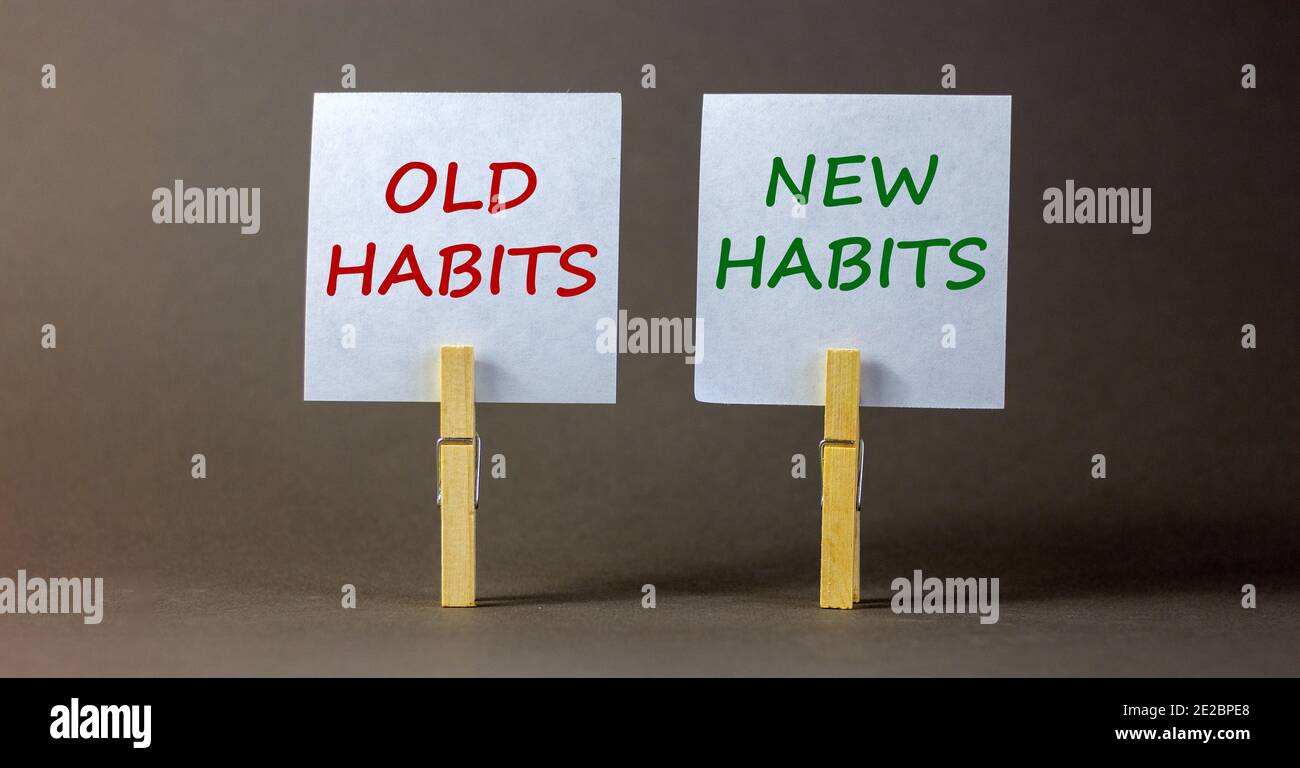 Old or new habits symbol. Wooden clothespins with white sheets of paper ...