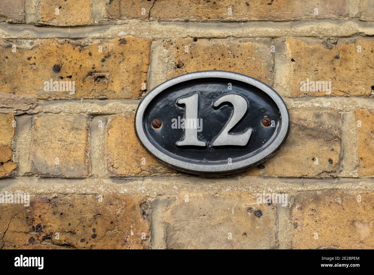 An oval plaque bearing the number twelve Stock Photo - Alamy
