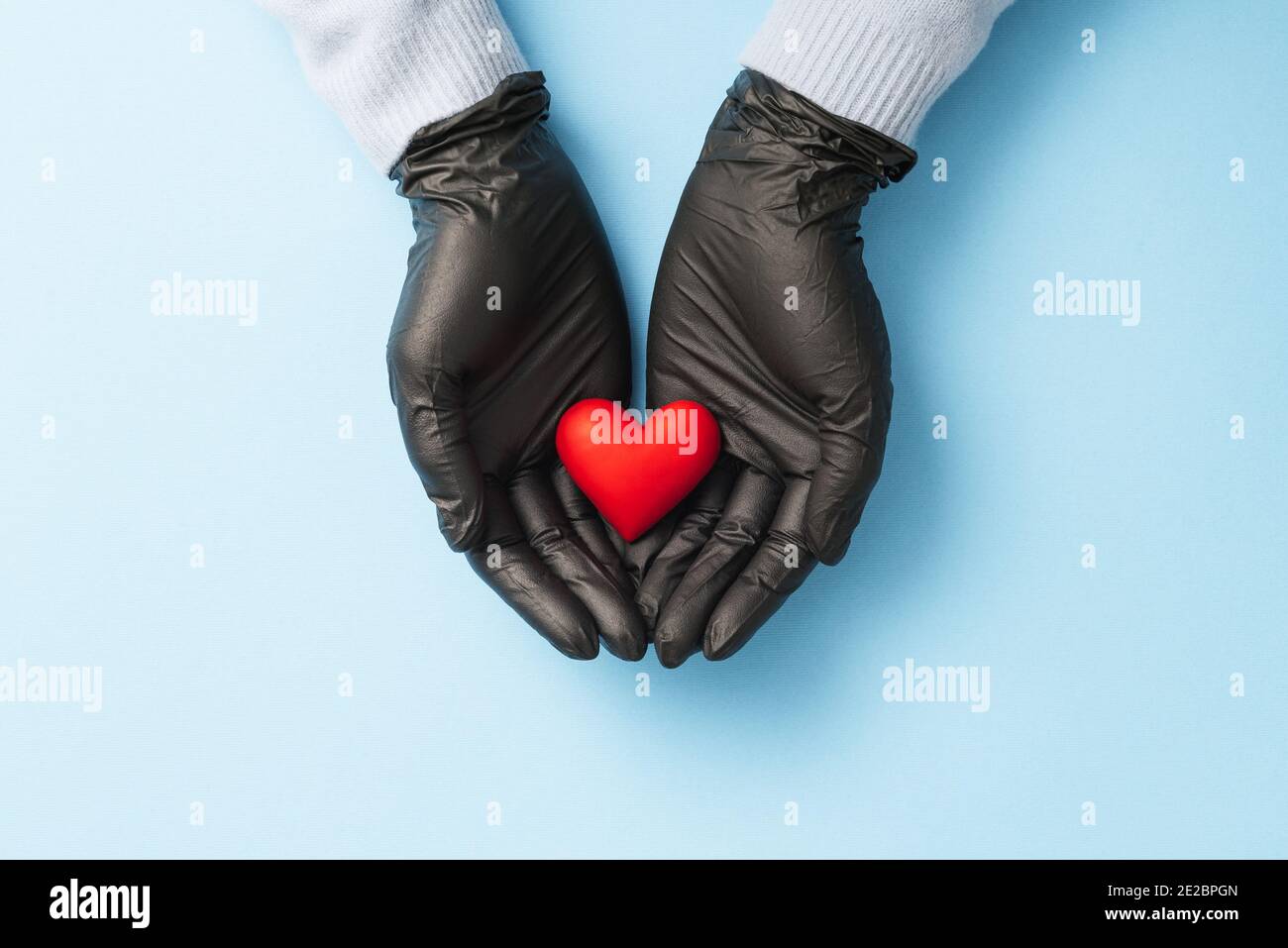 Valentines Day card with a red heart in the hands of a woman protected ... Valentines Day card with a red heart in the hands of a woman protected ...