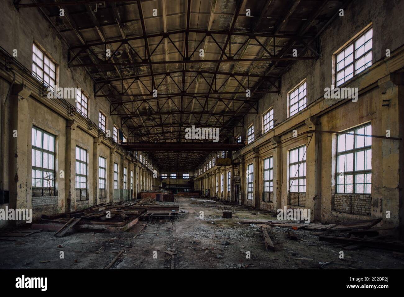 Abandoned factory. Large empty industrial hall with garbage Stock Photo ...