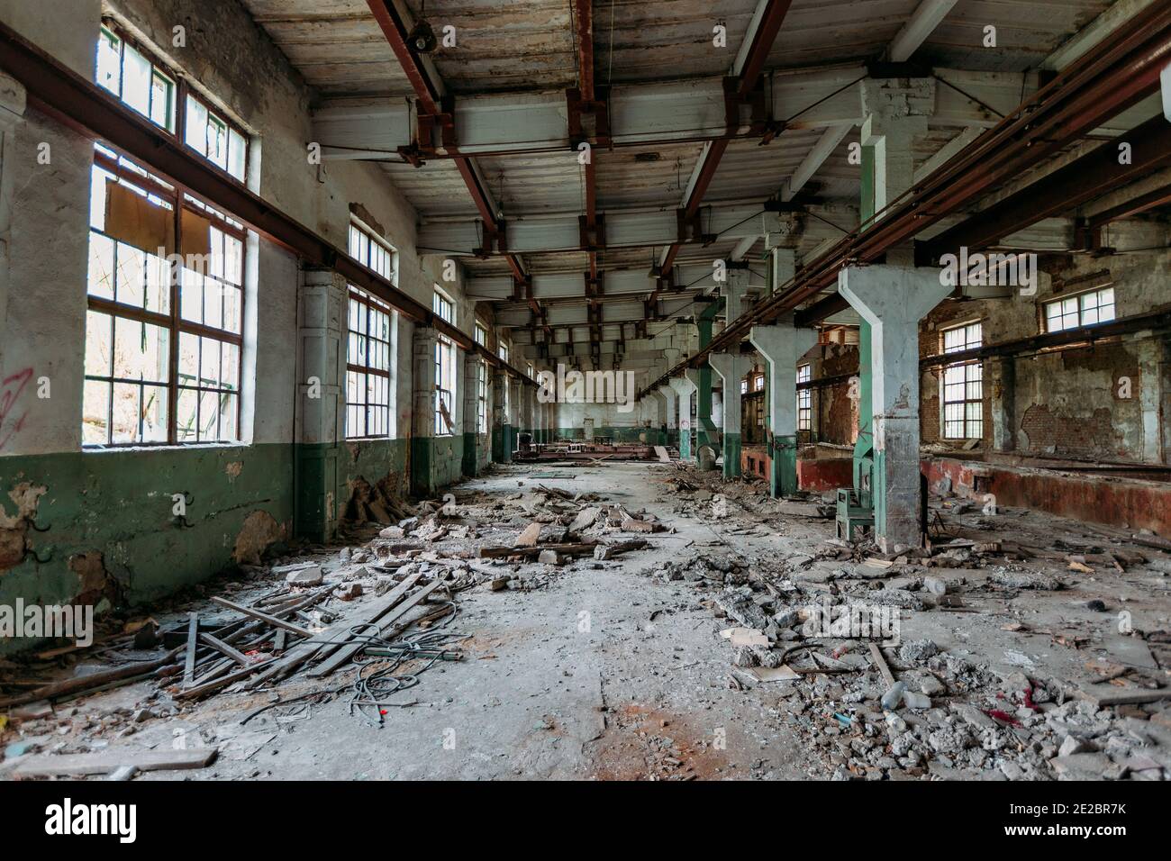 Abandoned factory. Large empty industrial hall with garbage Stock Photo ...