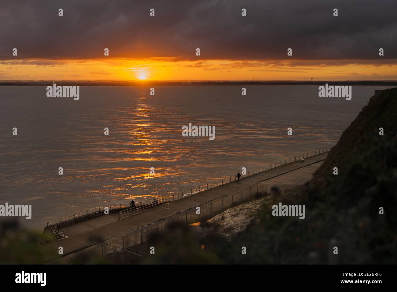 A break in heavy clouds allows for a beautiful sunset in Ramsgate, Kent ...