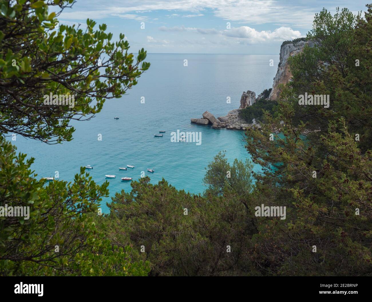 Aerial view of limestone rock and cliff at Cala Luna beach with group ...