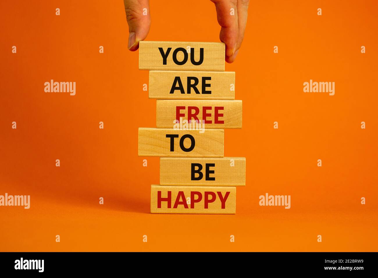 You are free to be happy symbol. Male hand. Wooden blocks tower with ...