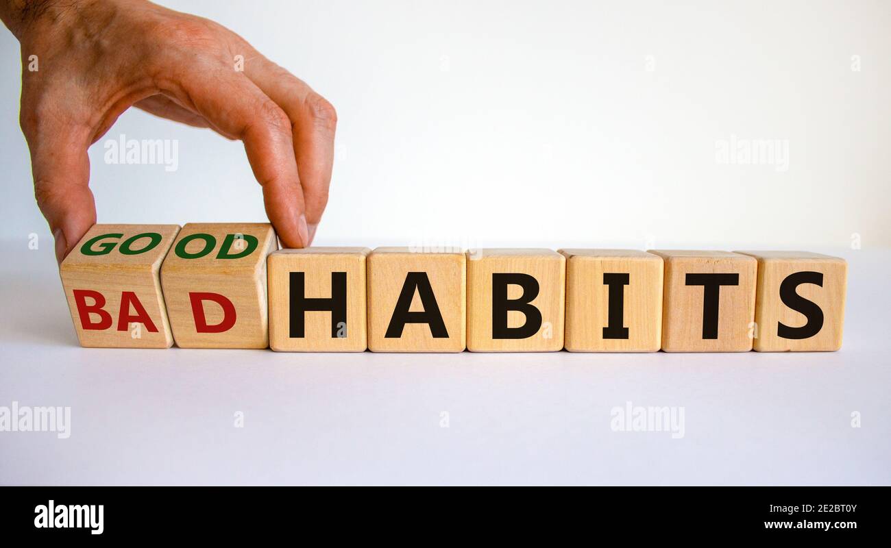 Good or bad habits symbol. Businessman hand turns wooden cubes and ...
