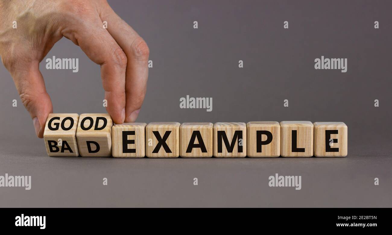 Good or bad example symbol. Businessman turns wooden cubes and changes ...