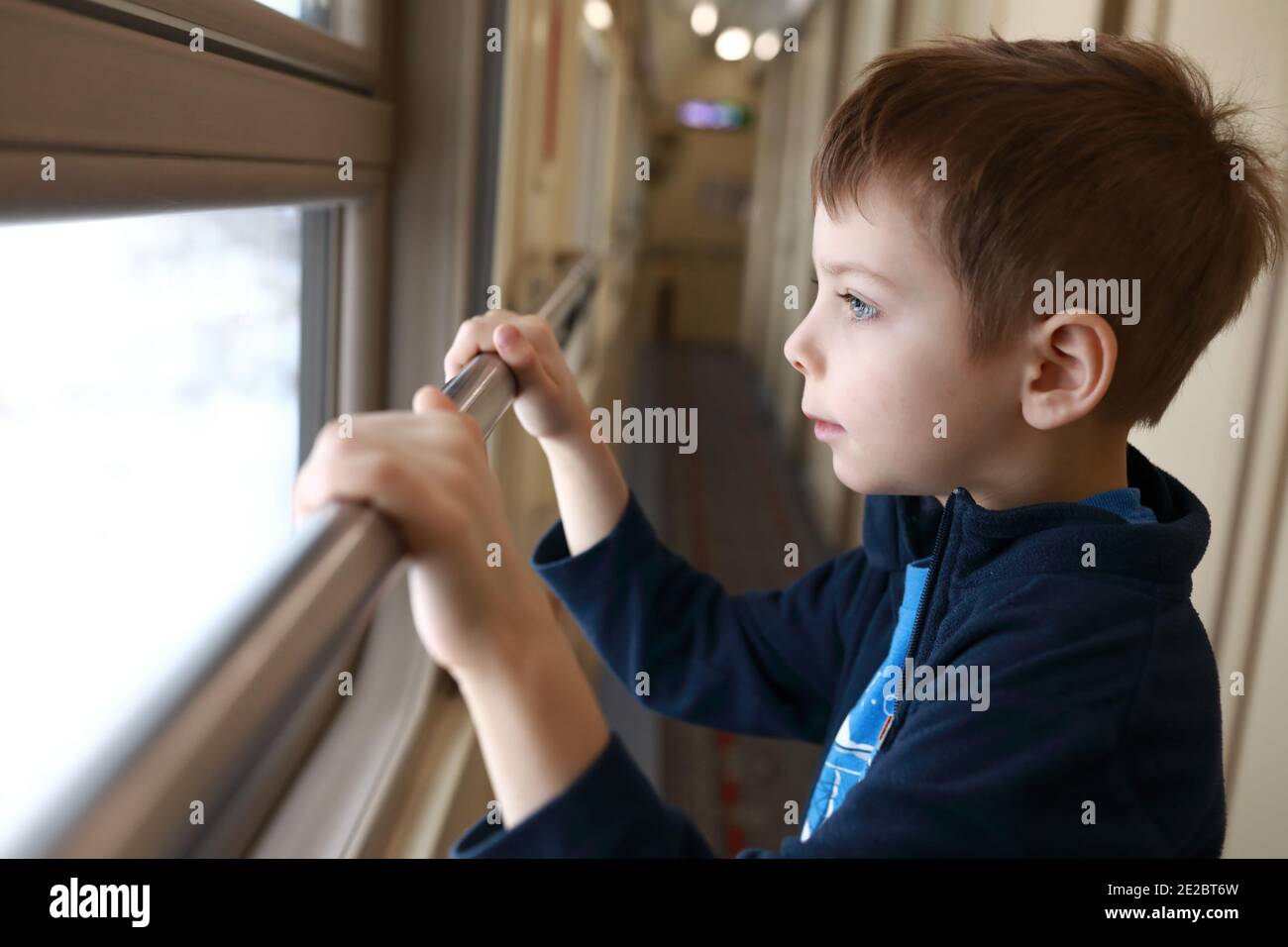 Portrait of child looking out train window Stock Photo - Alamy