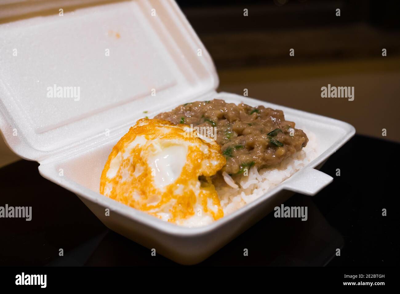Rice with beef and a fried egg (take away). Delicious signature meal ...