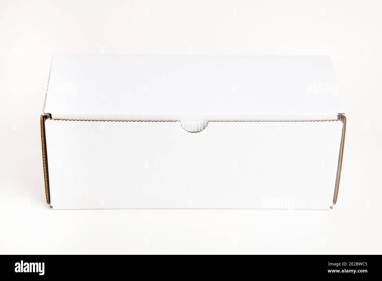 A closed white rectangular cardboard packaging box set on plain white ...