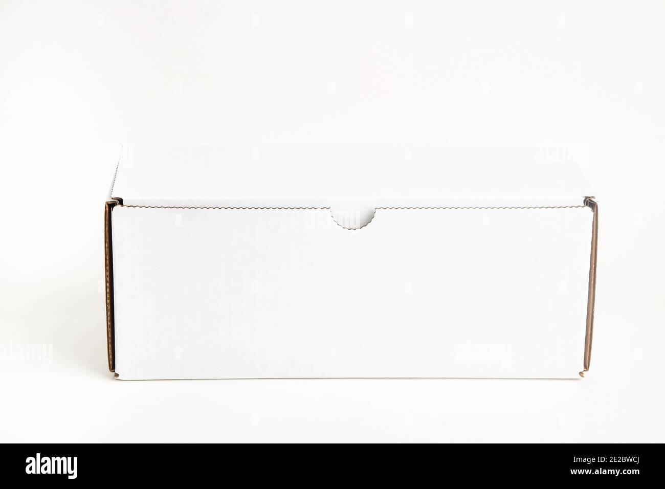 A closed white rectangular cardboard packaging box set on plain white ...
