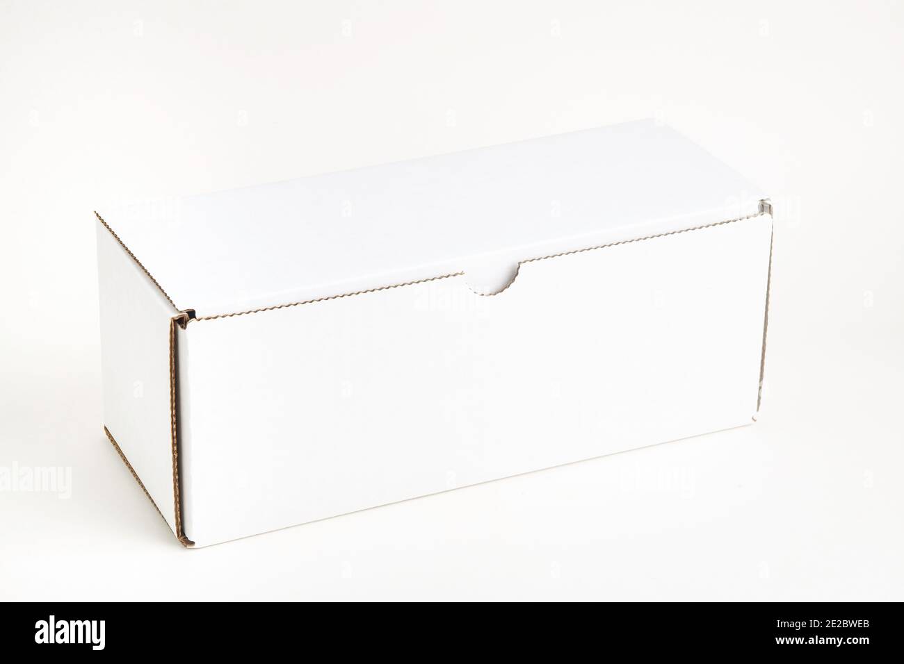 A closed white rectangular cardboard packaging box set on plain white ...