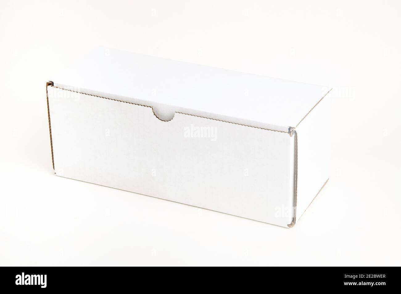A closed white rectangular cardboard packaging box set on plain white ...