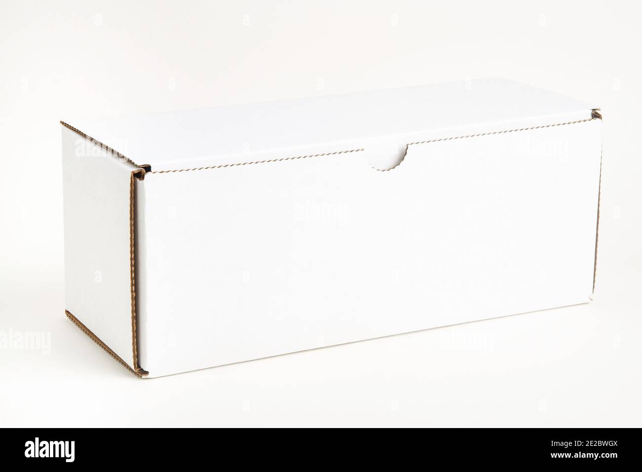 A closed white rectangular cardboard packaging box set on plain white ...