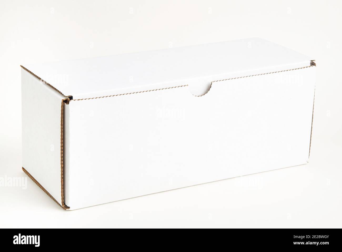 A closed white rectangular cardboard packaging box set on plain white ...
