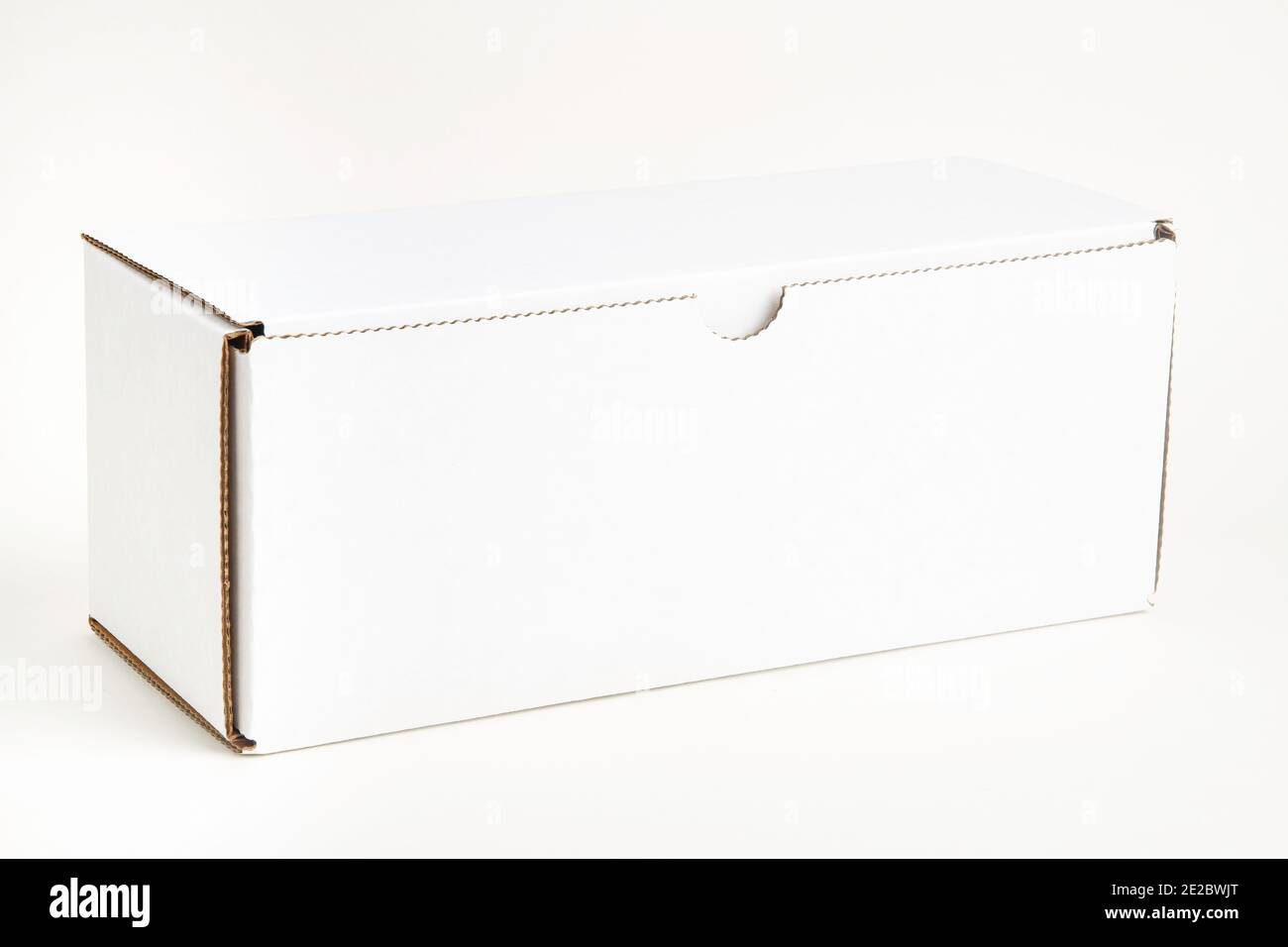 A closed white rectangular cardboard packaging box set on plain white ...
