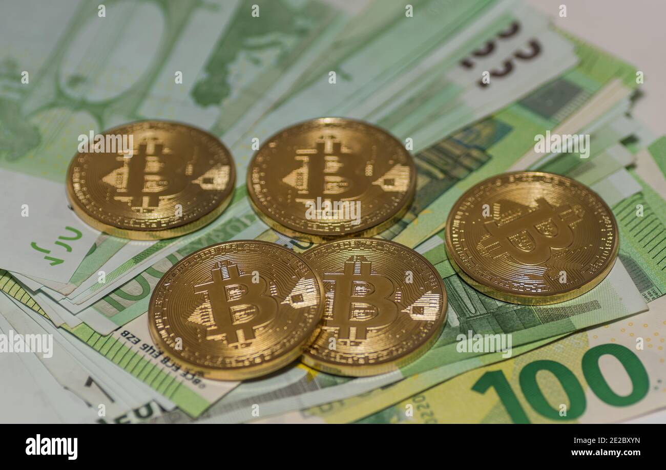 golden valuable bitcoins and many 100 euro bills view from above Stock ...