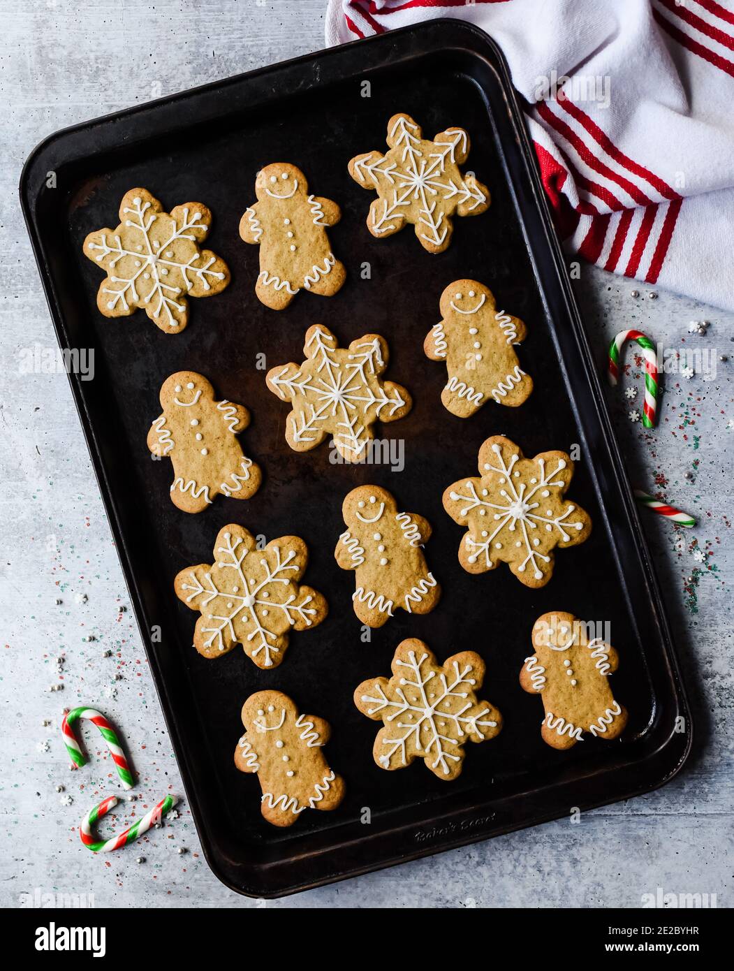 Overhead of gingerbread cookies on sheet pan on grey stone counter ...