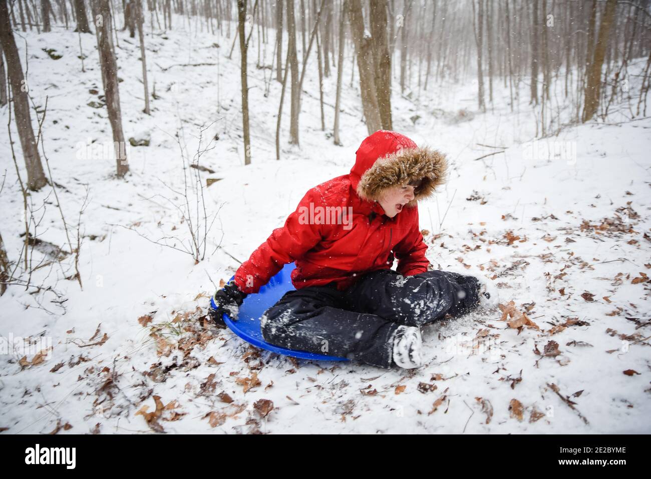 Boy sledding down hill hi-res stock photography and images - Alamy