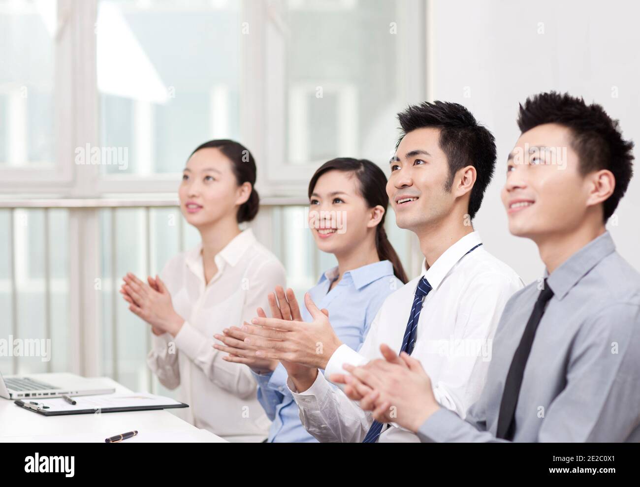 Young Business people applauding in office, smiling high quality photo ...