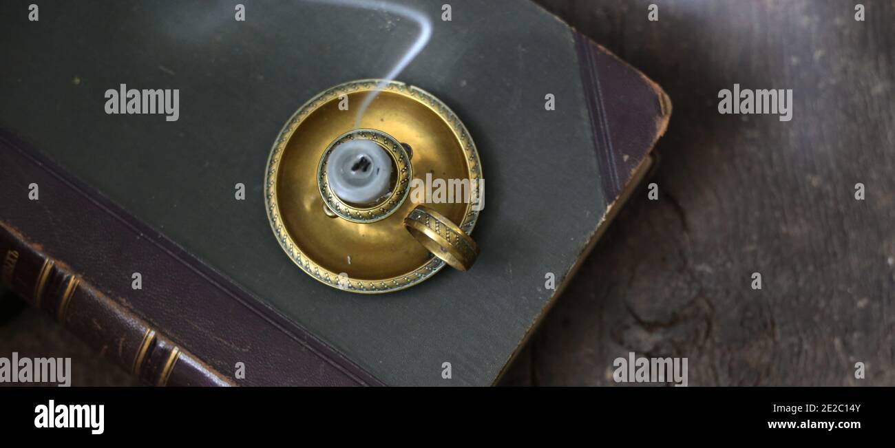 Old antique book, candle holder on old wood background. Memory, past ...