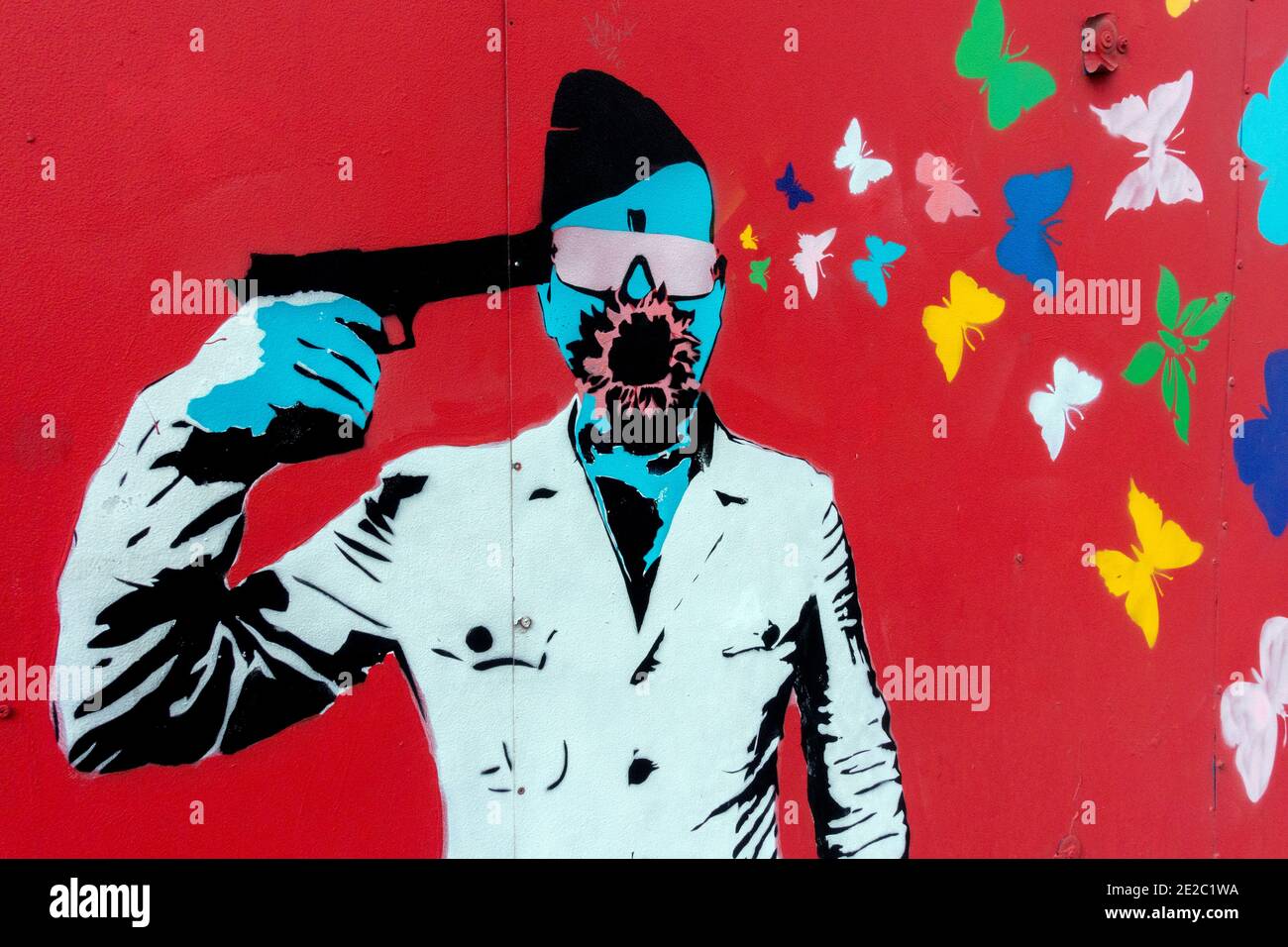 Stencil street art graffiti Man gun and butterflies Prague Stock Photo ...