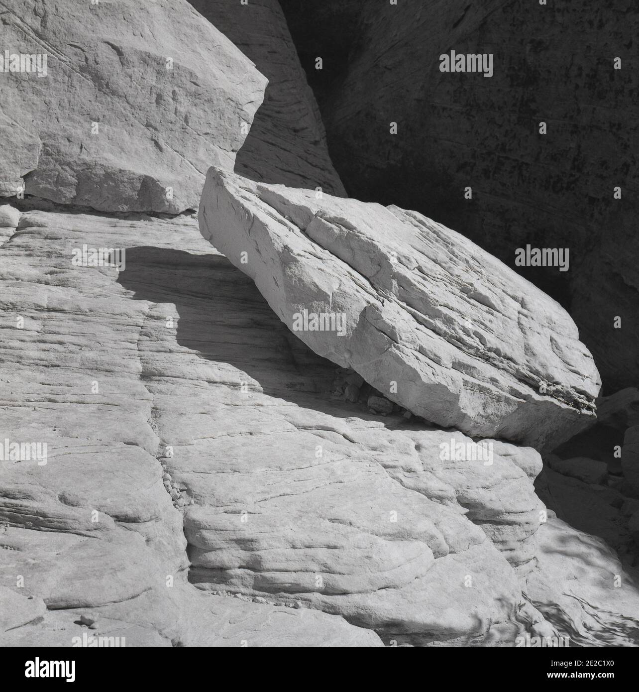 boulder balancing on rock face Stock Photo - Alamy